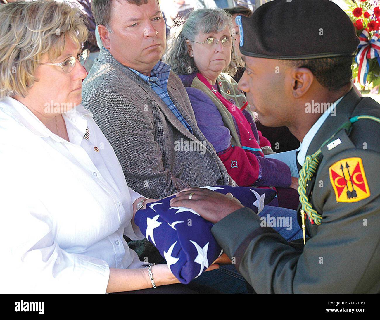 Debbie Fuller, left, of Indianola, accepts a flag from U.S. Army 1st Lt ...