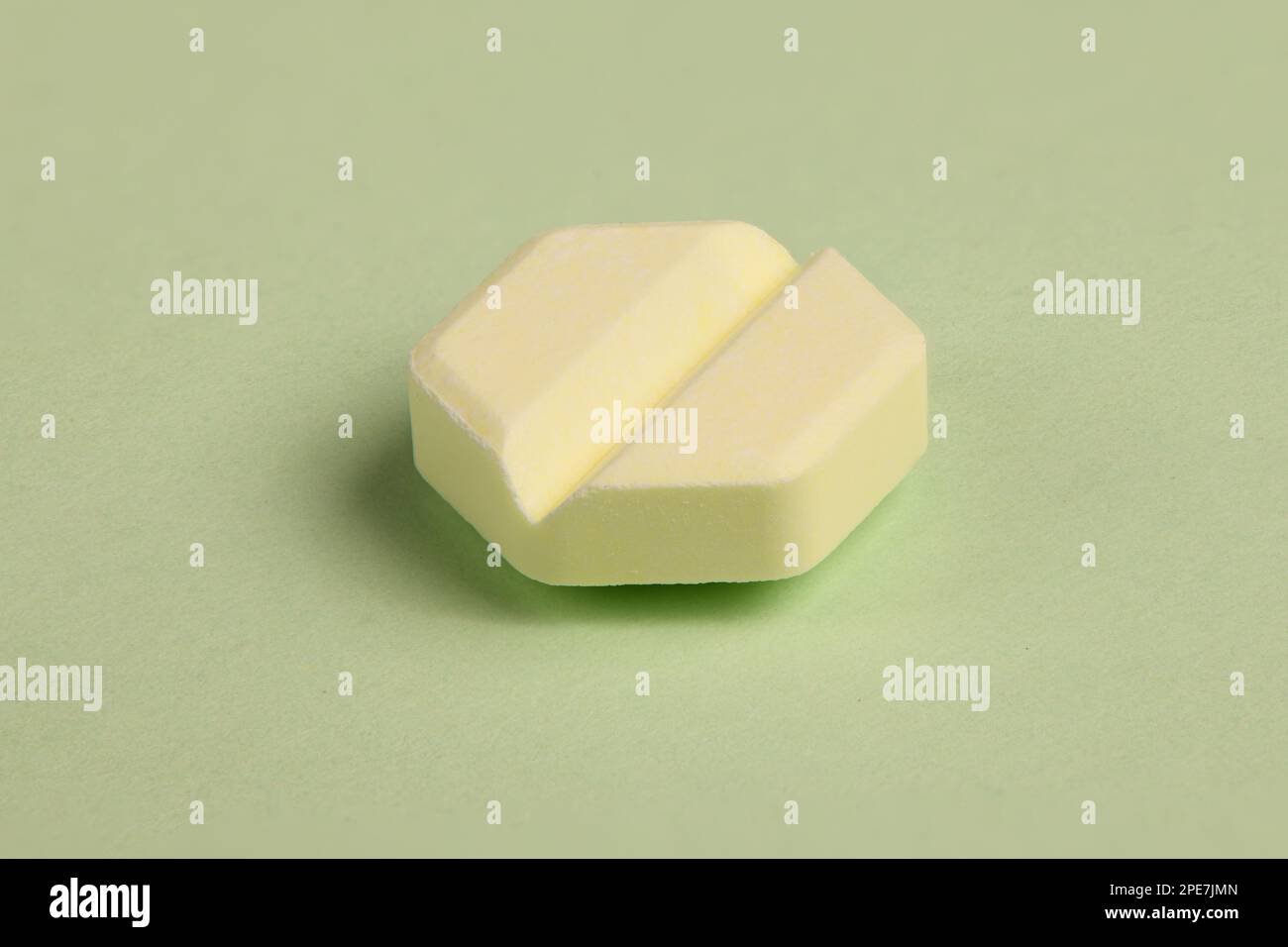 Hexagonal pills on light green background. Extreme closeup. High ...