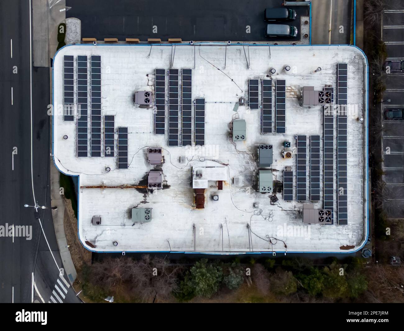 An aerial top view of an office building with solar panels on the roof ...