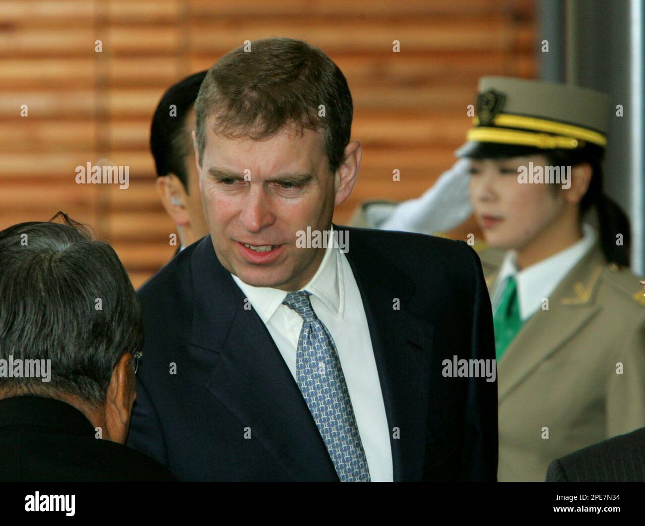 Britain's Prince Andrew is welcomed by a Japanese official of the Aichi ...