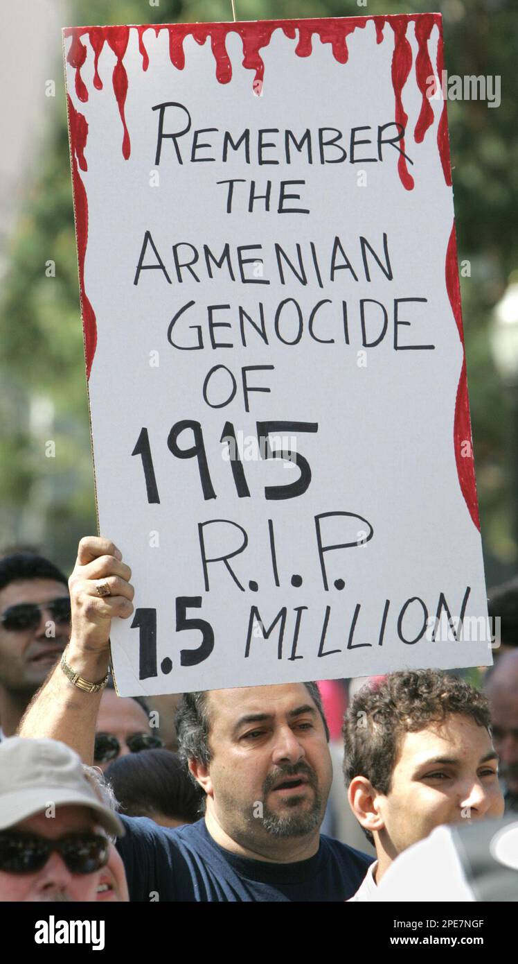 Sako Shirikina, of San Francisco, holds up a sign recalling the ...