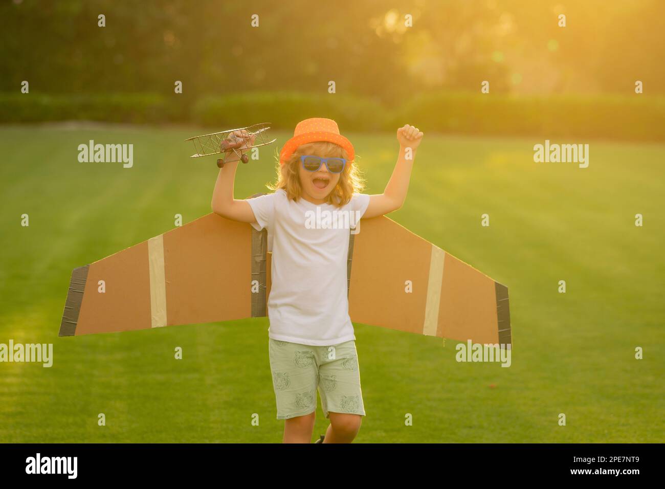 Kid playing with toy airplane and dreaming future. Happy boy pilot play ...