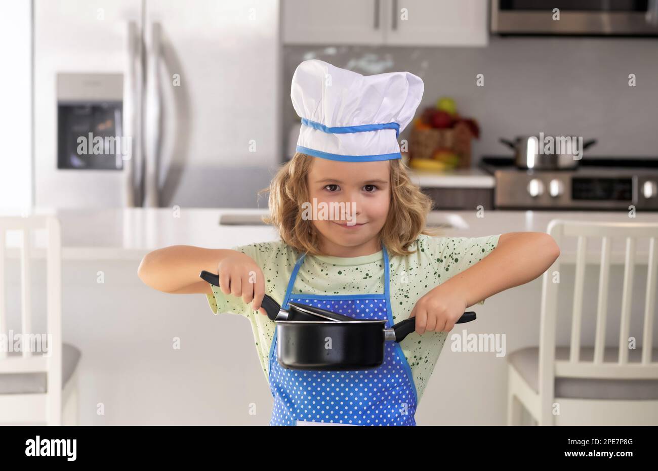 Funny kid chef cook cookery at kitchen. Chef kid boy making healthy ...