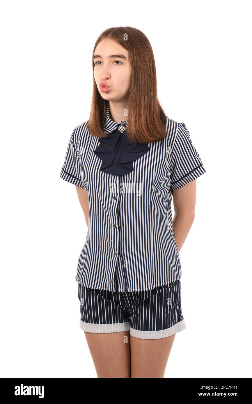 Young beautiful girl in a school uniform on a white background ...