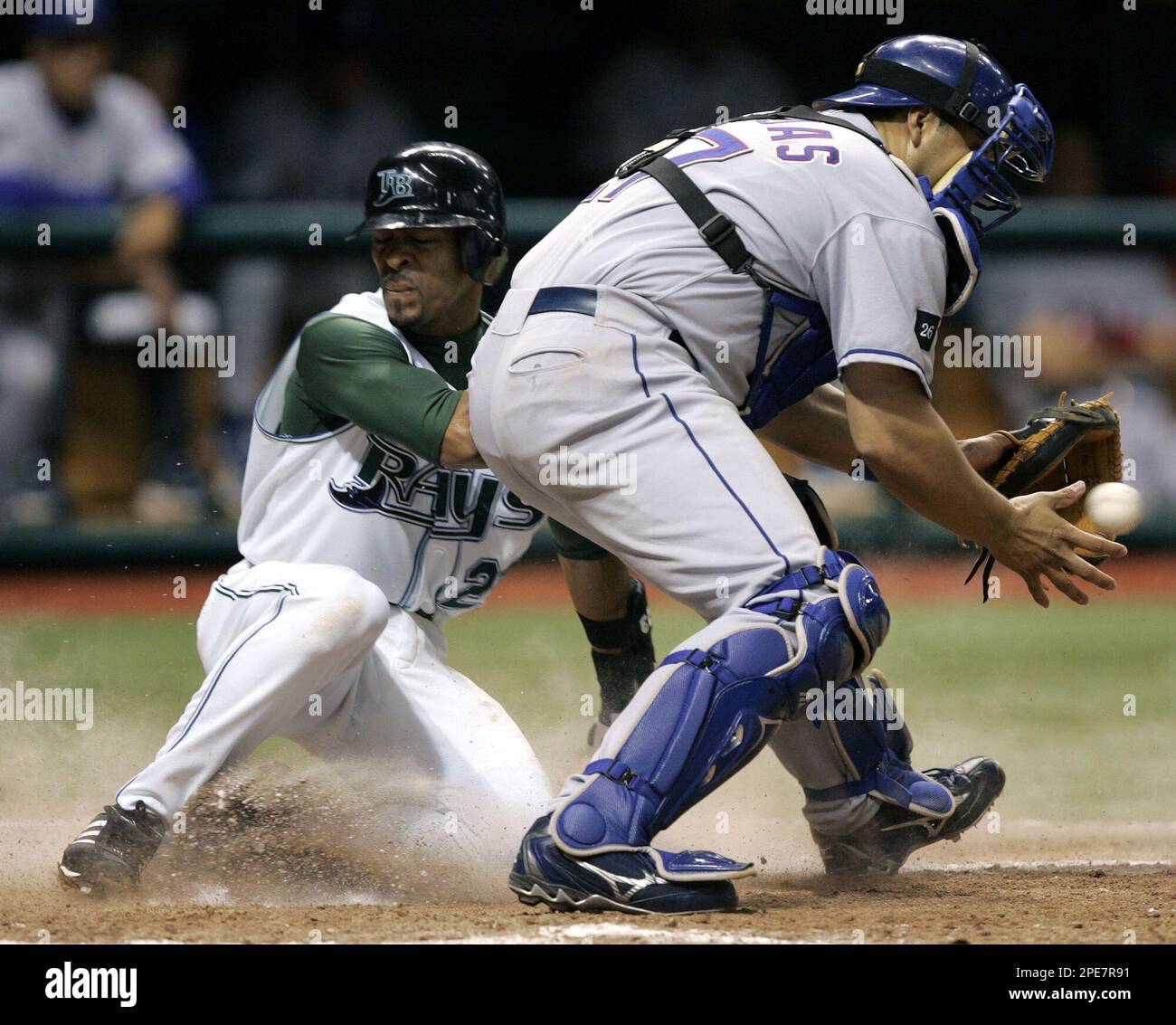 Tampa Bay Devil Rays' Julio Lugo scores on an RBI single by Jorge Cantu ...