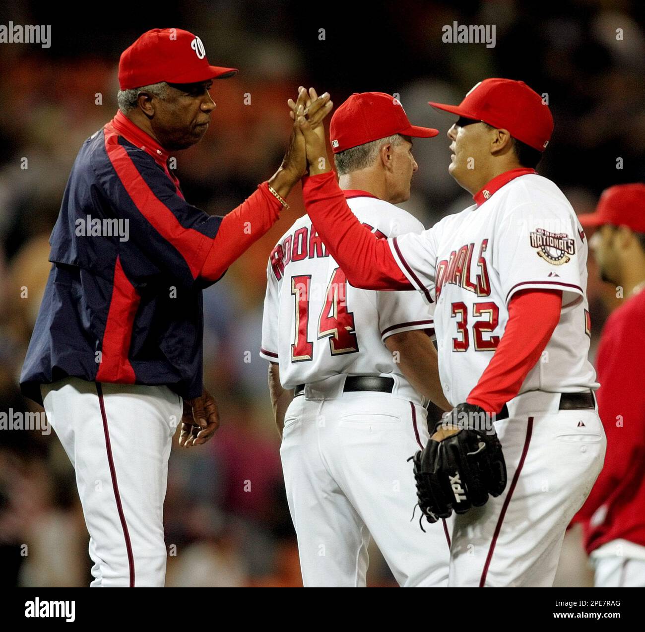 Washington Nationals manager Frank Robinson, left, congratulates relief ...