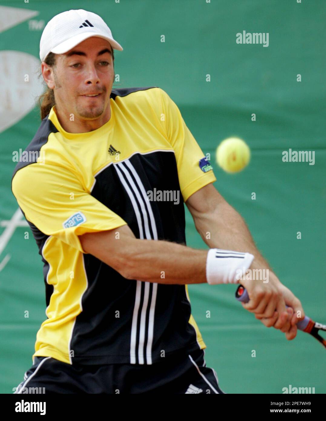 Fourth seeded Nicolas Massu, of Chile returns a shot to Antony Dupuis ...