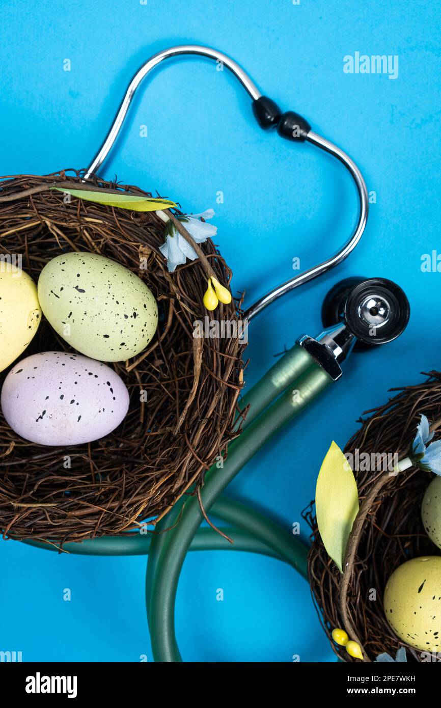 Easter Medicine. Two nests with painted eggs and a stethoscope on a ...