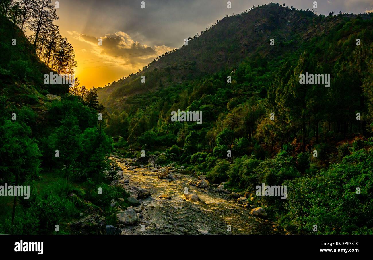 Setting sun lights up the Tirthan River in the Tirthan Valley Stock ...