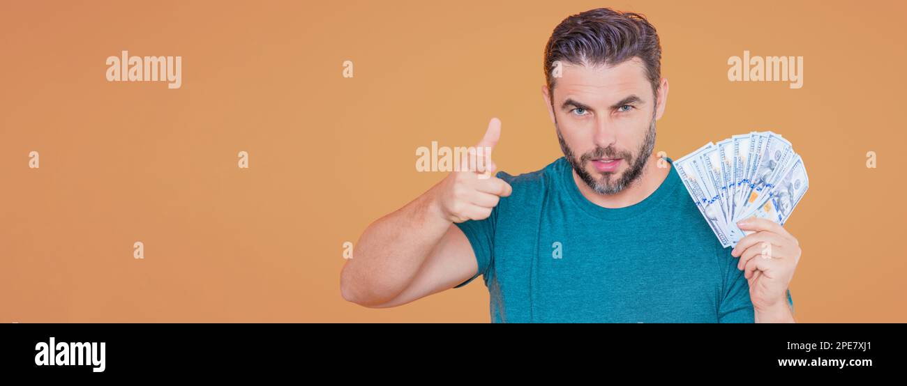 Man hold money on beige studio isolated banner background. Rich man in ...