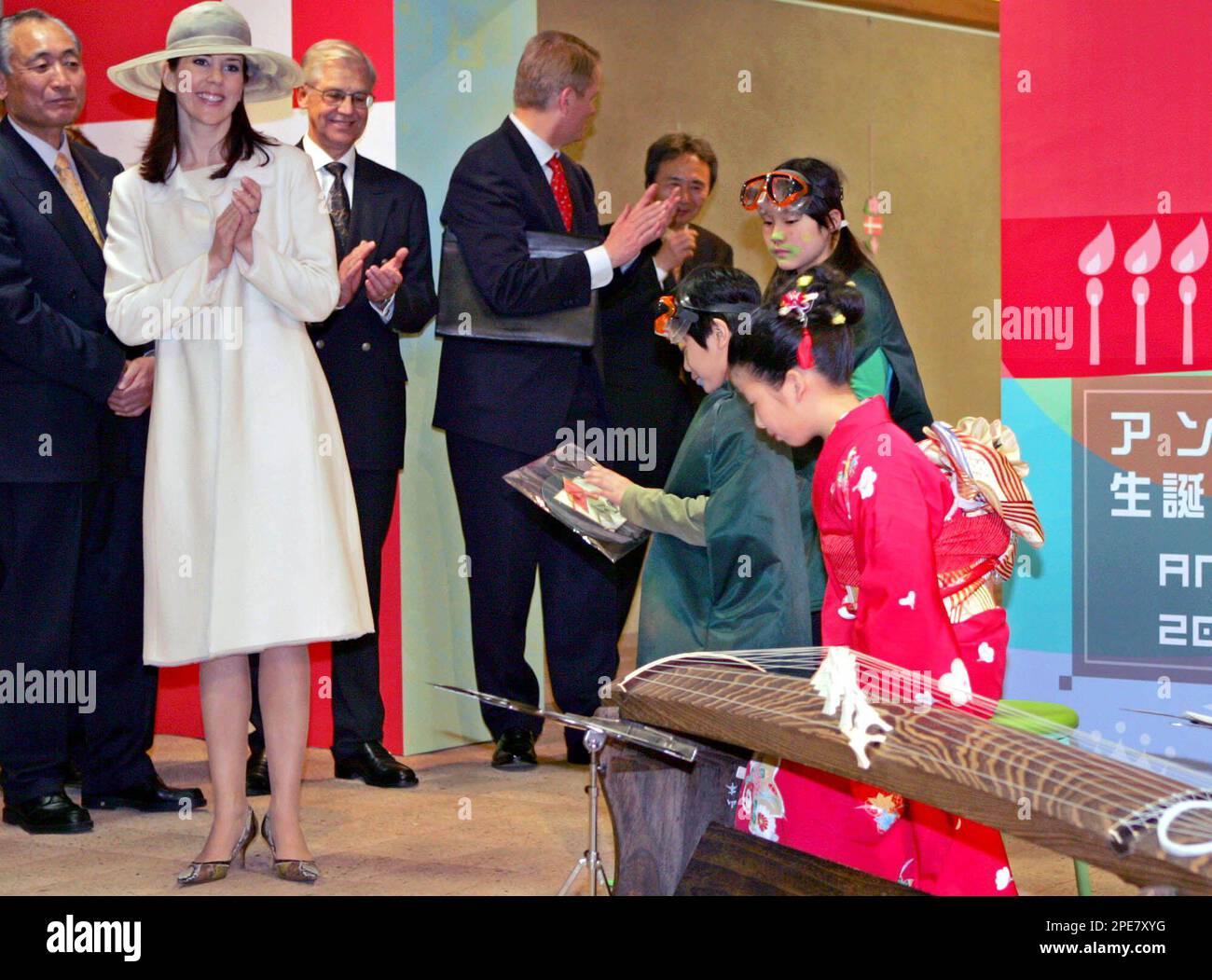 Crown Princess Mary of Denmark, left, claps her hands as Mariko Mine ...