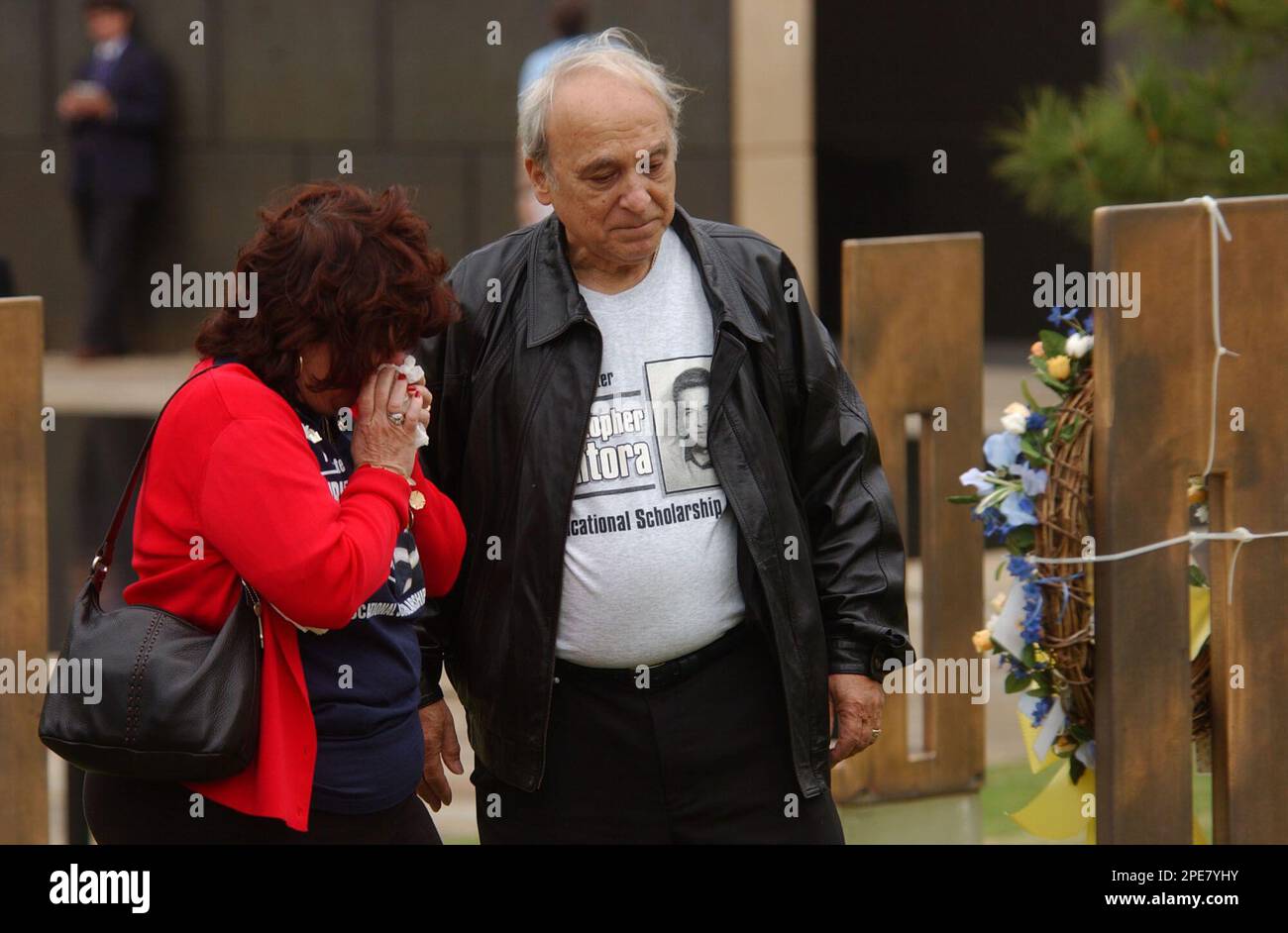 Maureen Santora cries as she and her husband, Alexander, look at one of ...