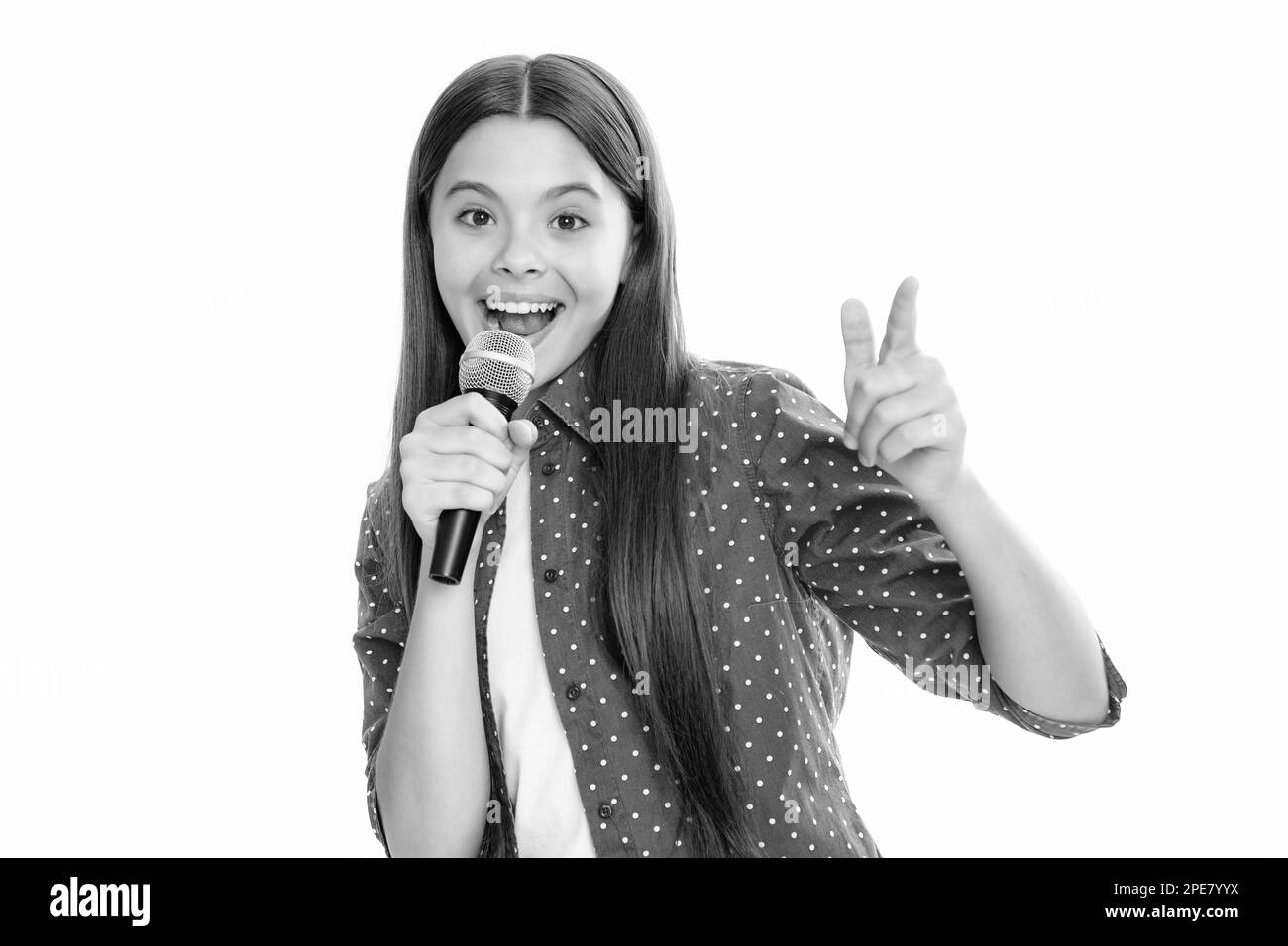Happy cute teen girl singing a song on microphone. Close-up portrait of ...