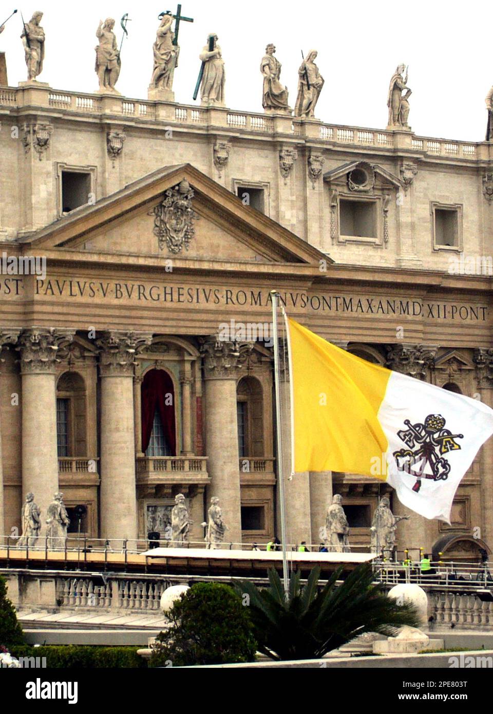 A yellow-and-white Vatican flag waves in front of the central balcony ...