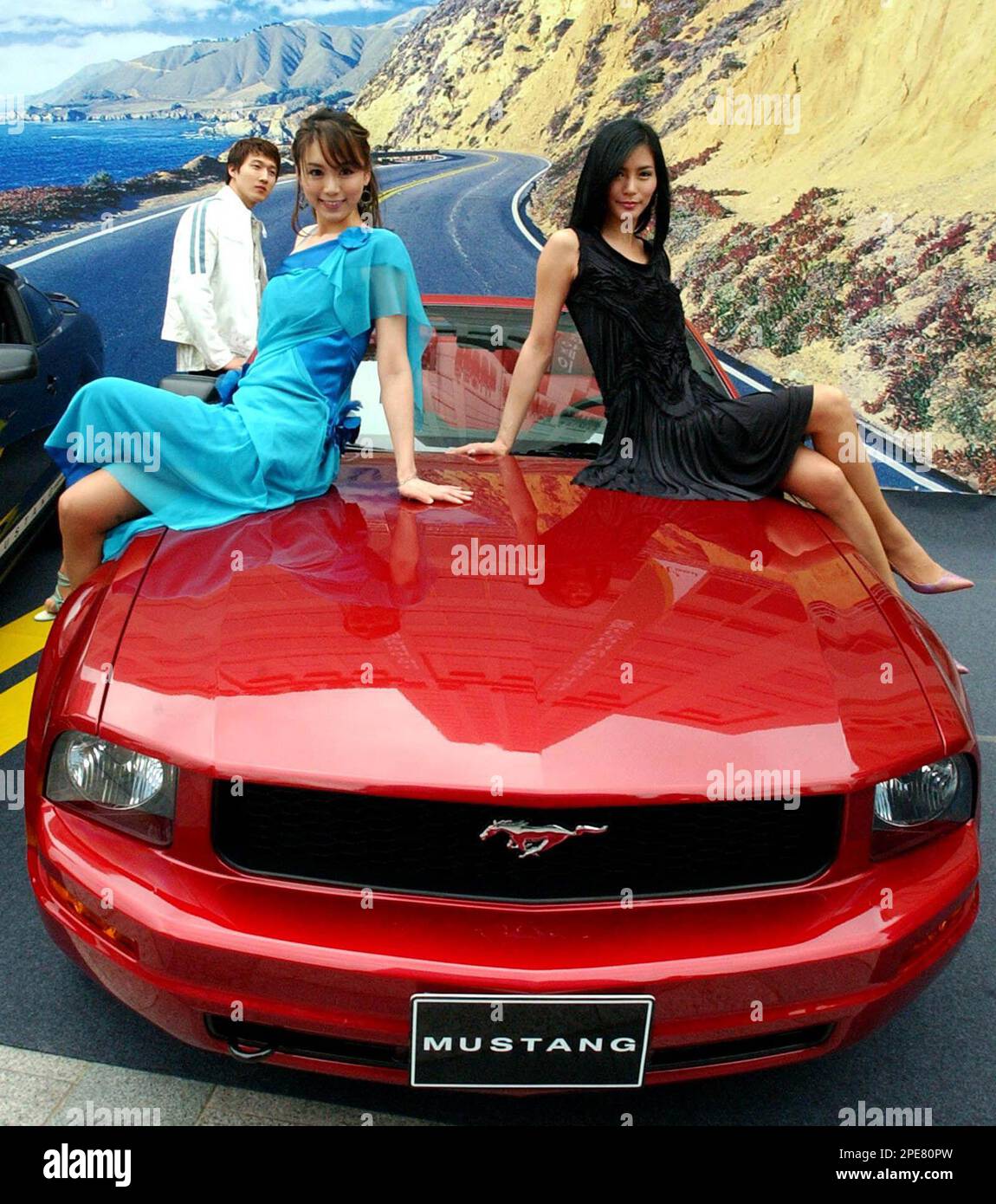 South Korean models pose with a Ford's New Mustang during a press ...