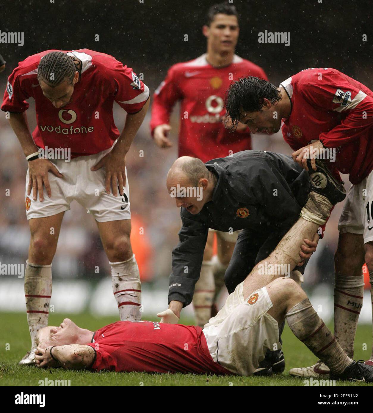 Manchester United's Wayne Rooney, bottom, is treated for cramp shortly ...