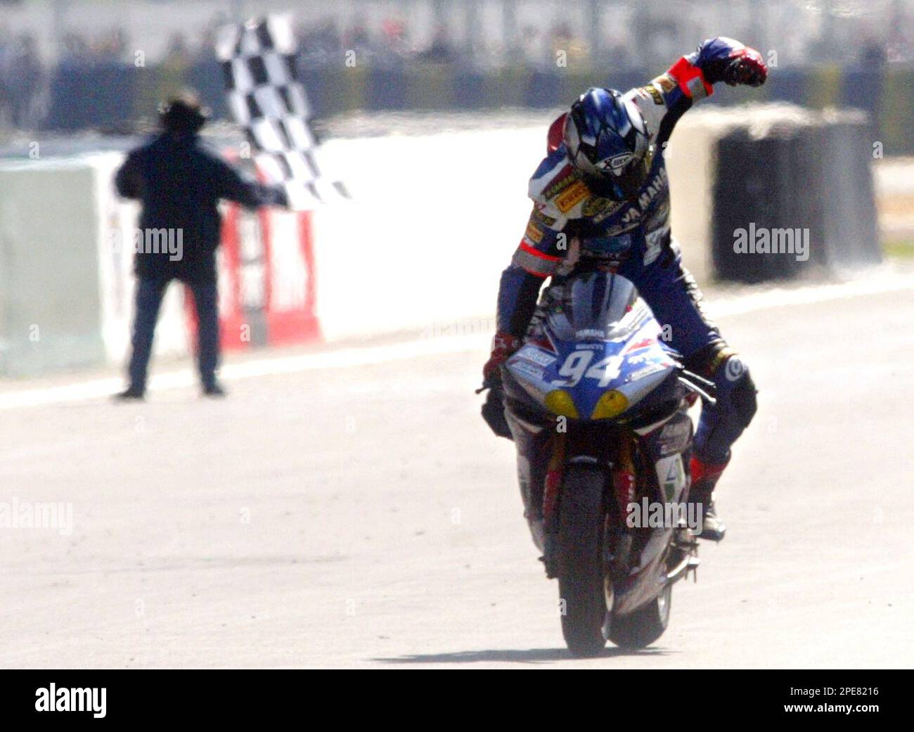 Spanish rider David Checa reacts as he crosses the finish line on his ...