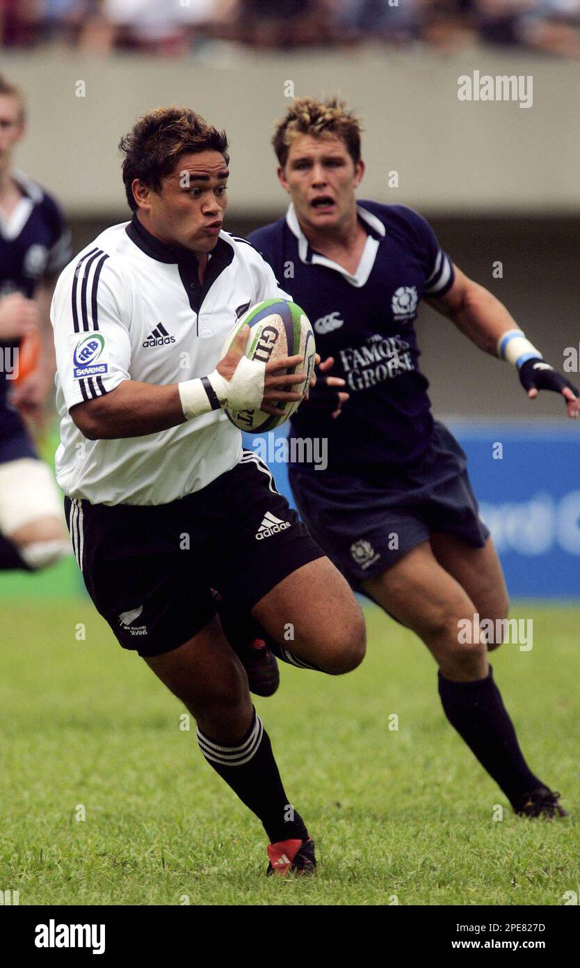 New Zealand's Nigel Hunt, left, runs with Scotland's Oliver Brown in ...