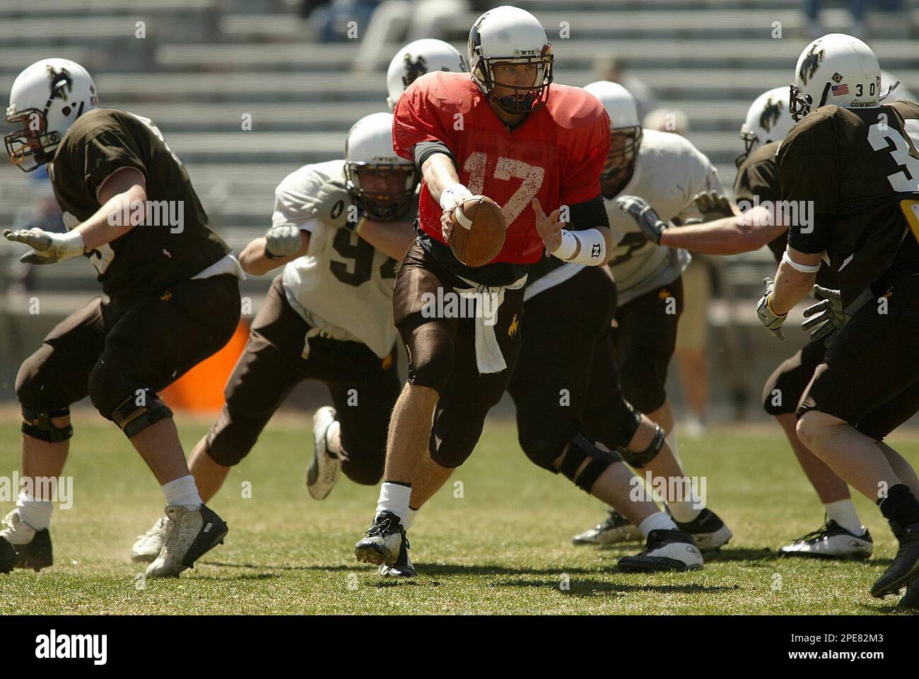 Wyoming quarterback Corey Bramlet, center, prepares to hand off to ...