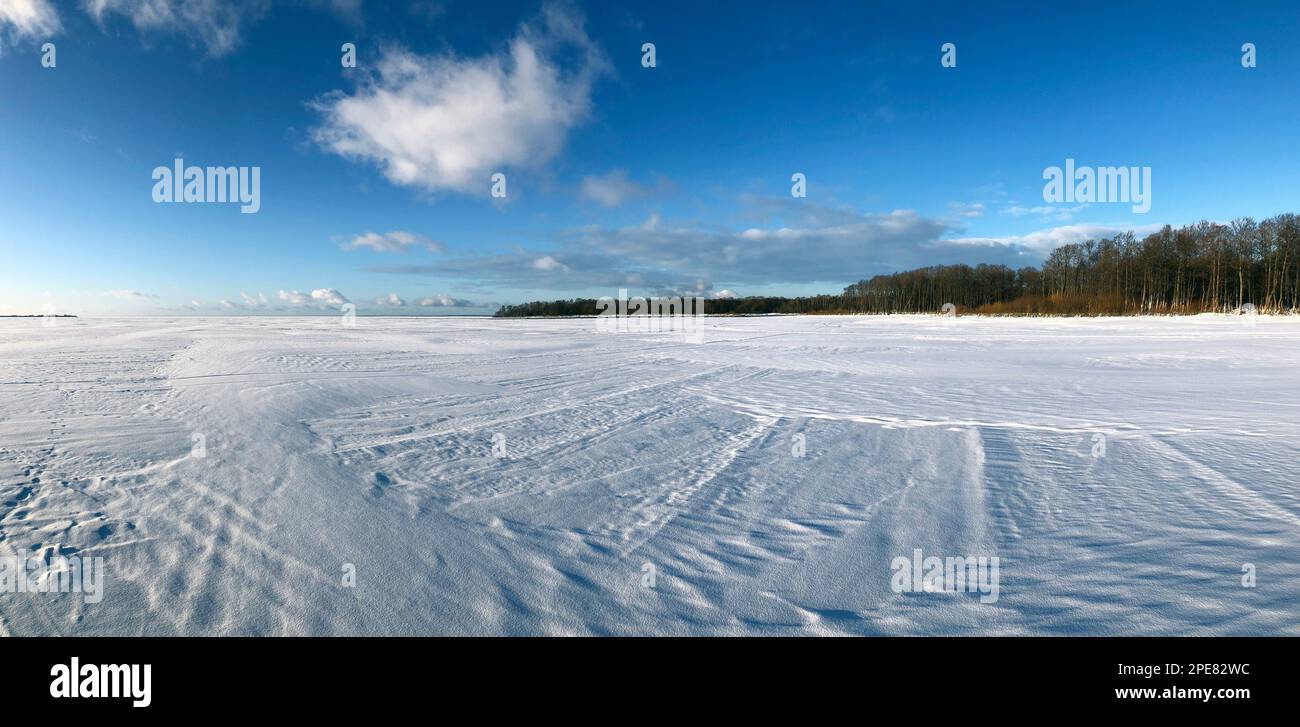 winter panorama, frozen endless expanse of the lake, white snow with ...