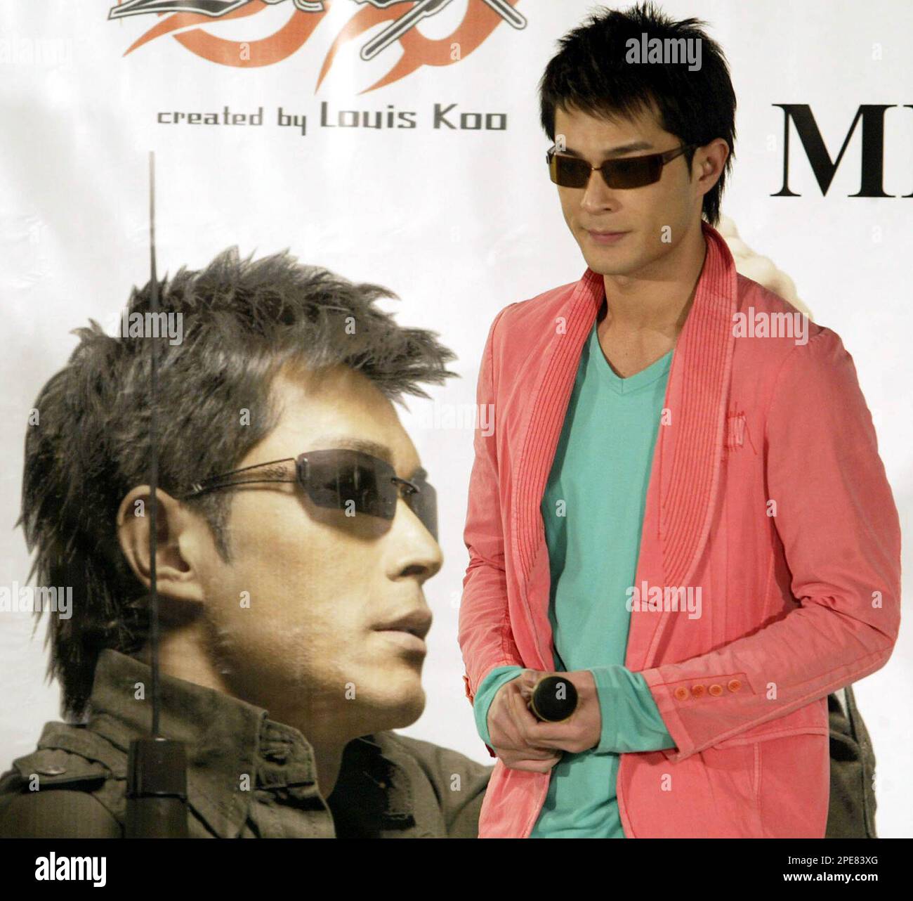 Hong Kong actor Louis Khoo poses in front of his picture during an ...