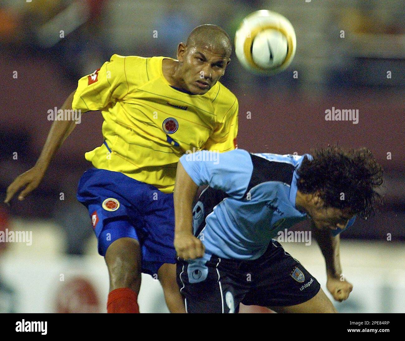 Colombia's Alexander Mejia, left, heads the ball beside Uruguay's Elias ...