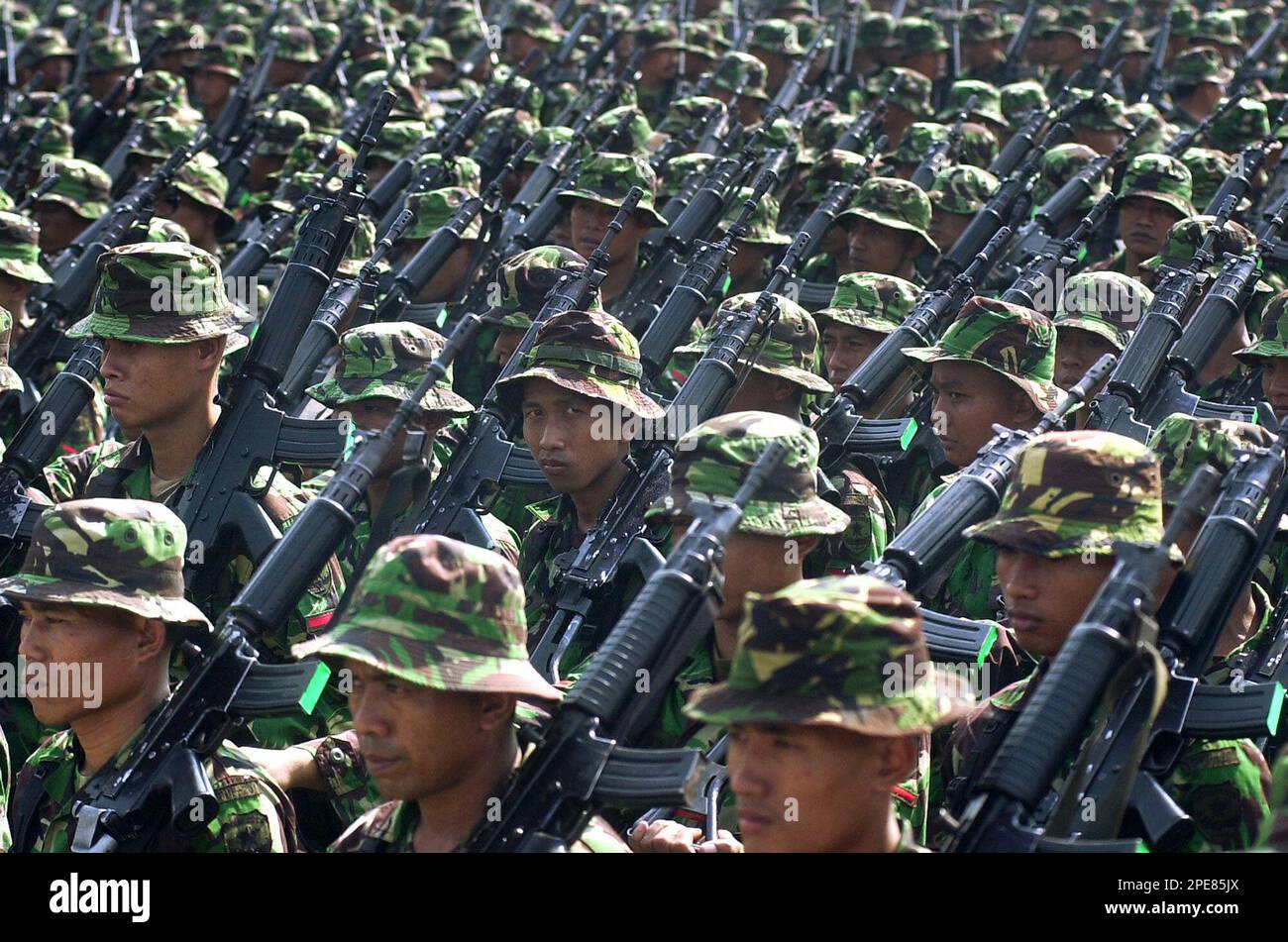 Indonesian soldiers carry rifles on their shoulders during a show of ...
