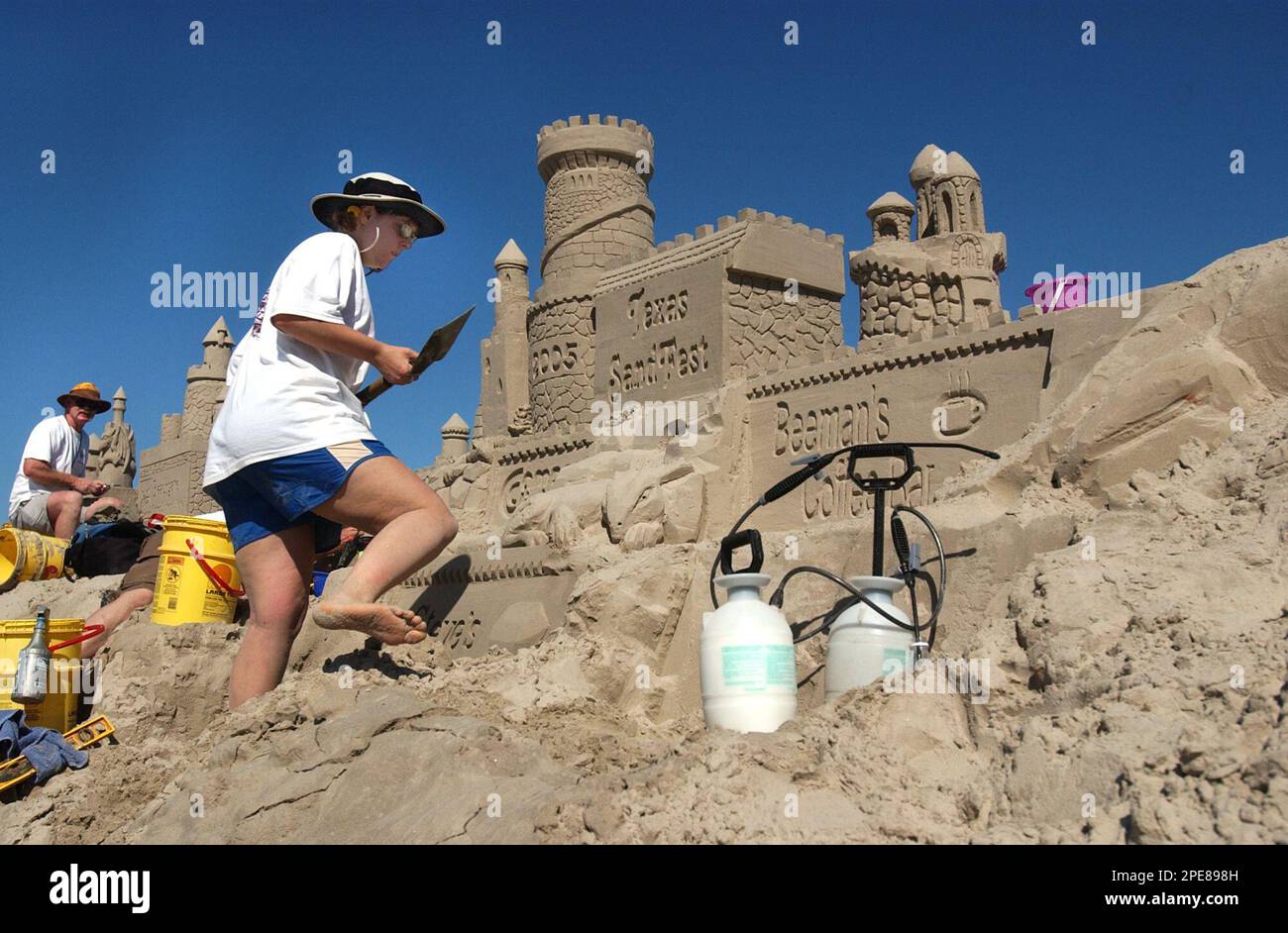 Master sand sculptor Karen Fralich of Toronto climbs the sides of the ...