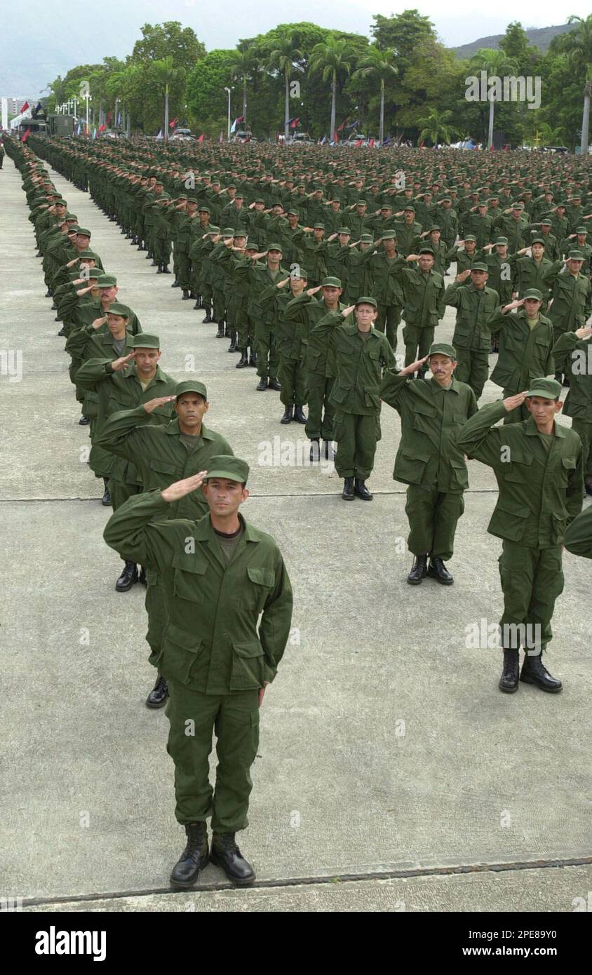 Members of the military reserve salute as they practice for a ceremony ...