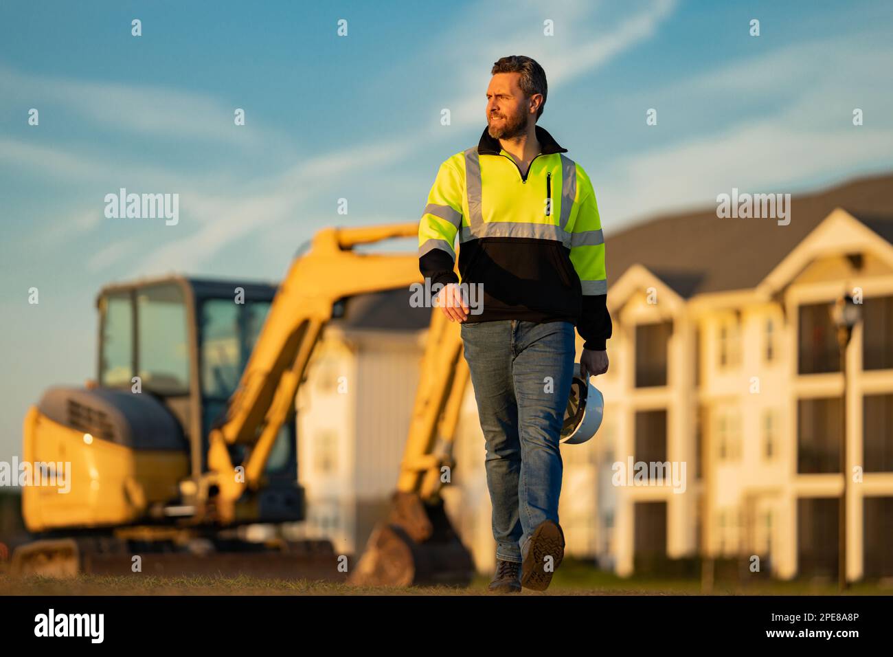 Worker in helmet on site construction. Man excavator bulldozer worker ...
