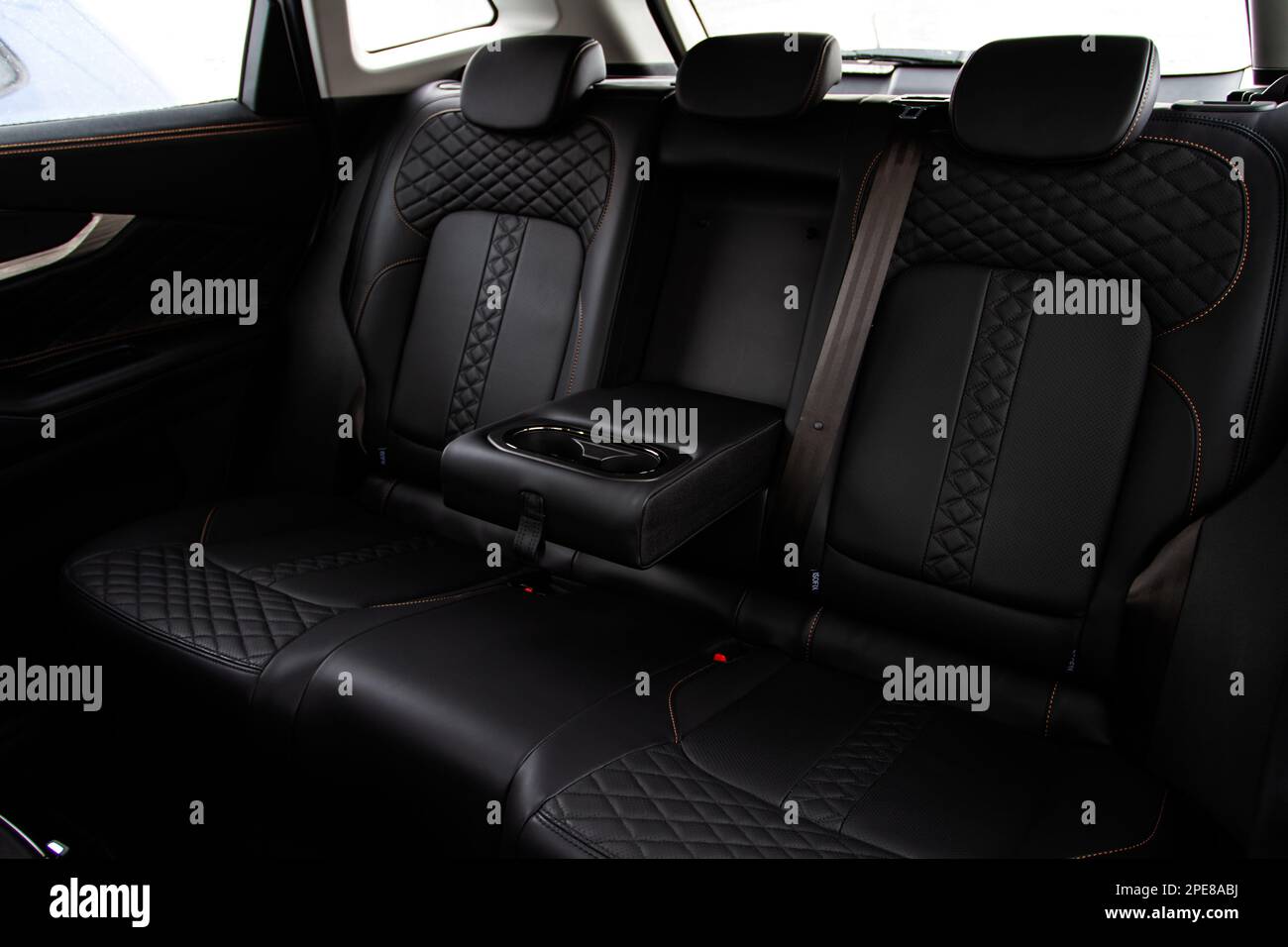 Modern car inside. Leather passenger seats with opened armrest ...
