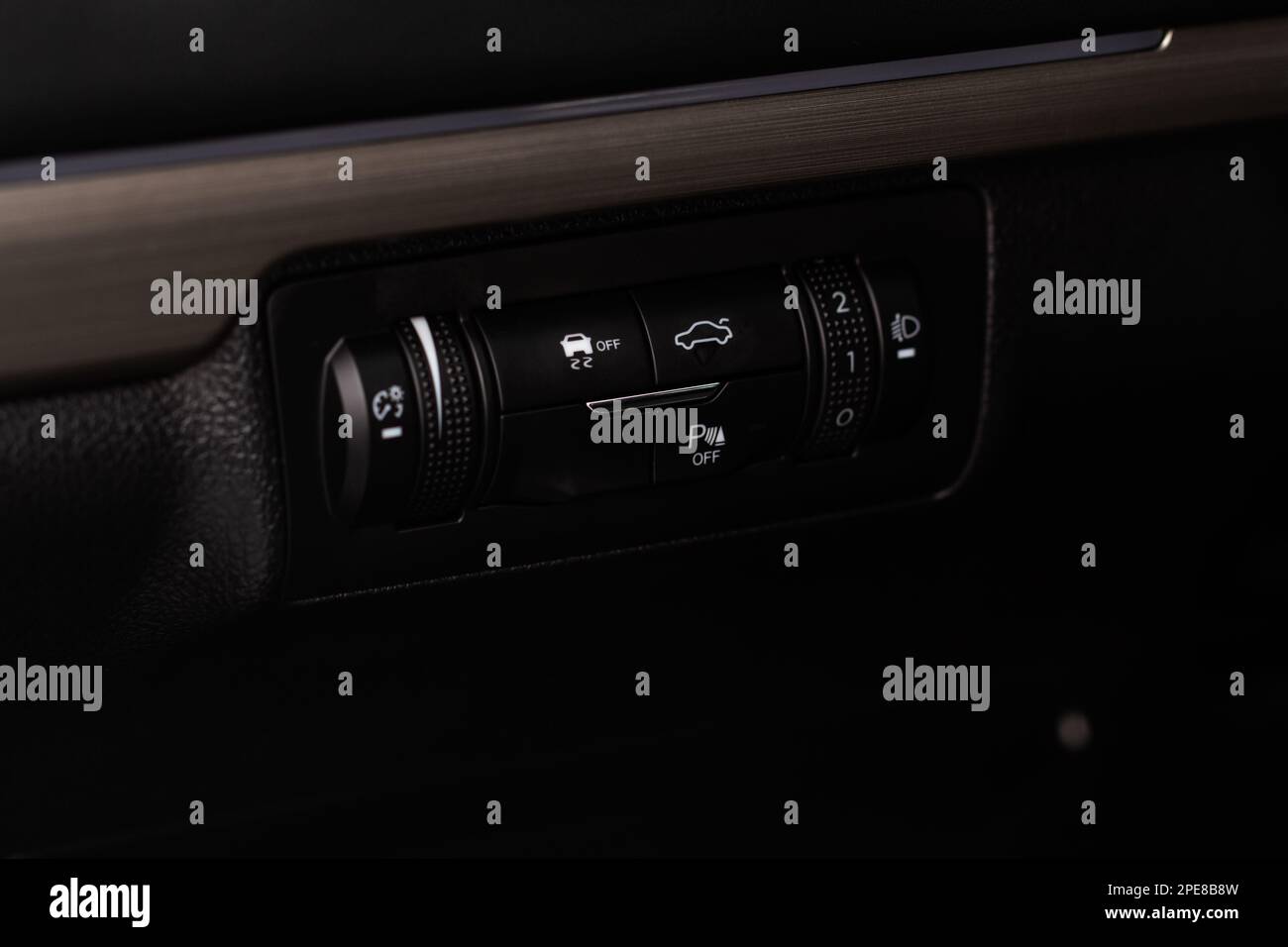 Hand operating ESP (electronic stability program) control close up view ...