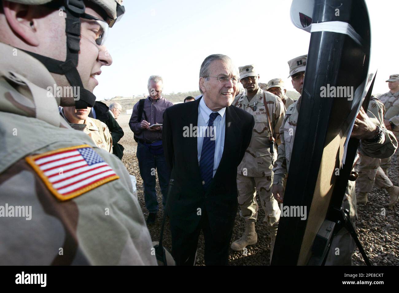 US Defence Secretary Donald Rumsfeld looks at a chart showing ...