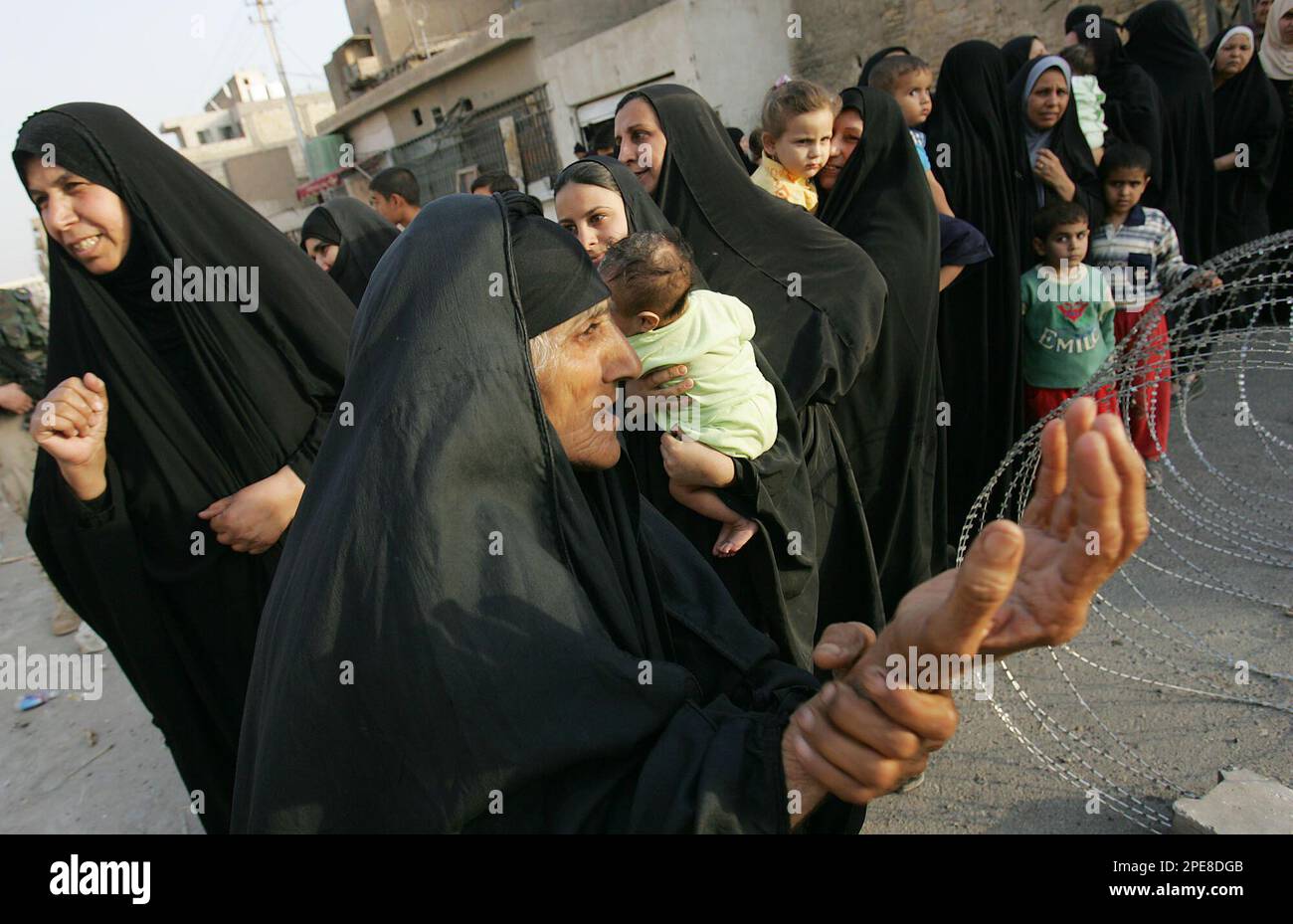 Iraqi women wait in line to access a field clinic set by 3rd Infantry ...
