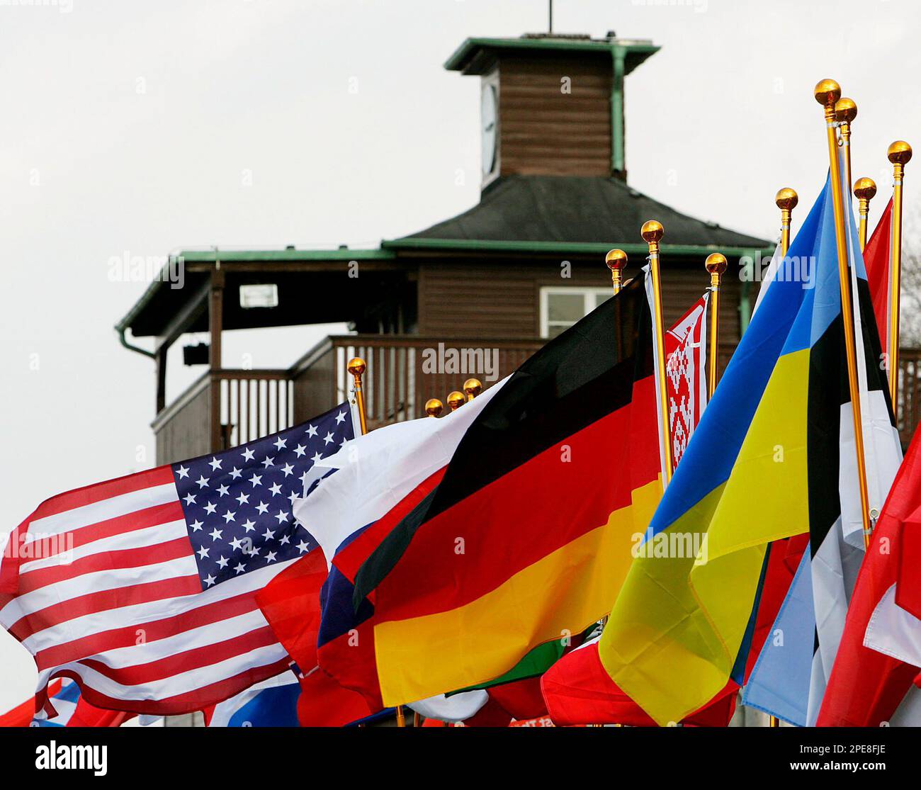 Flags of many nations flutter in the wind in front of the camp entrance ...