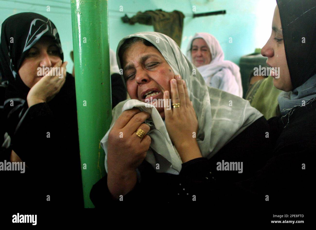 Relatives of 14-year-old Ashraf Moussa mourn at the family house during ...