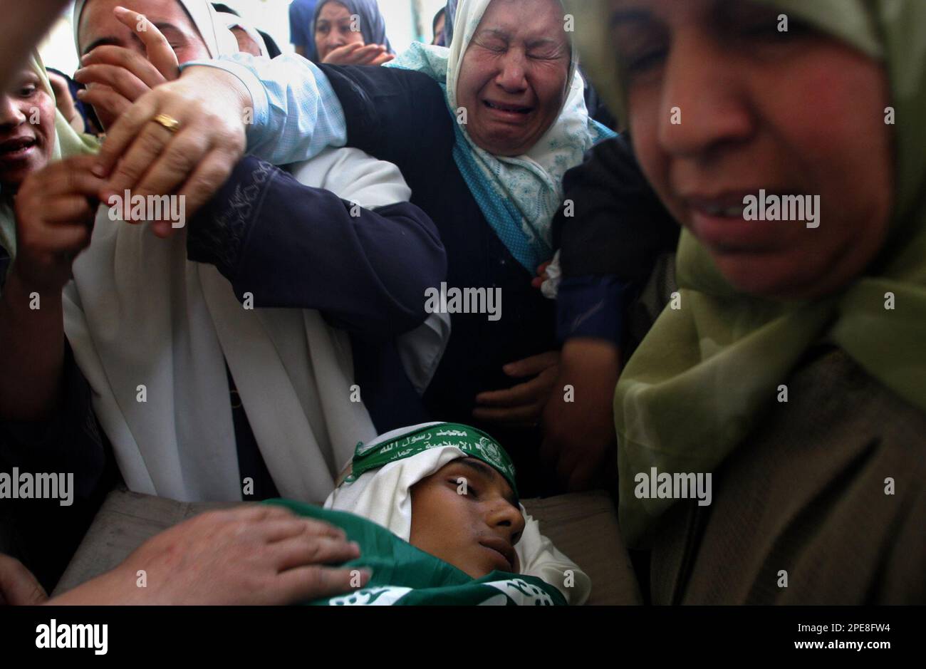Relatives of 14-year-old Ashraf Moussa mourn at the family house during ...