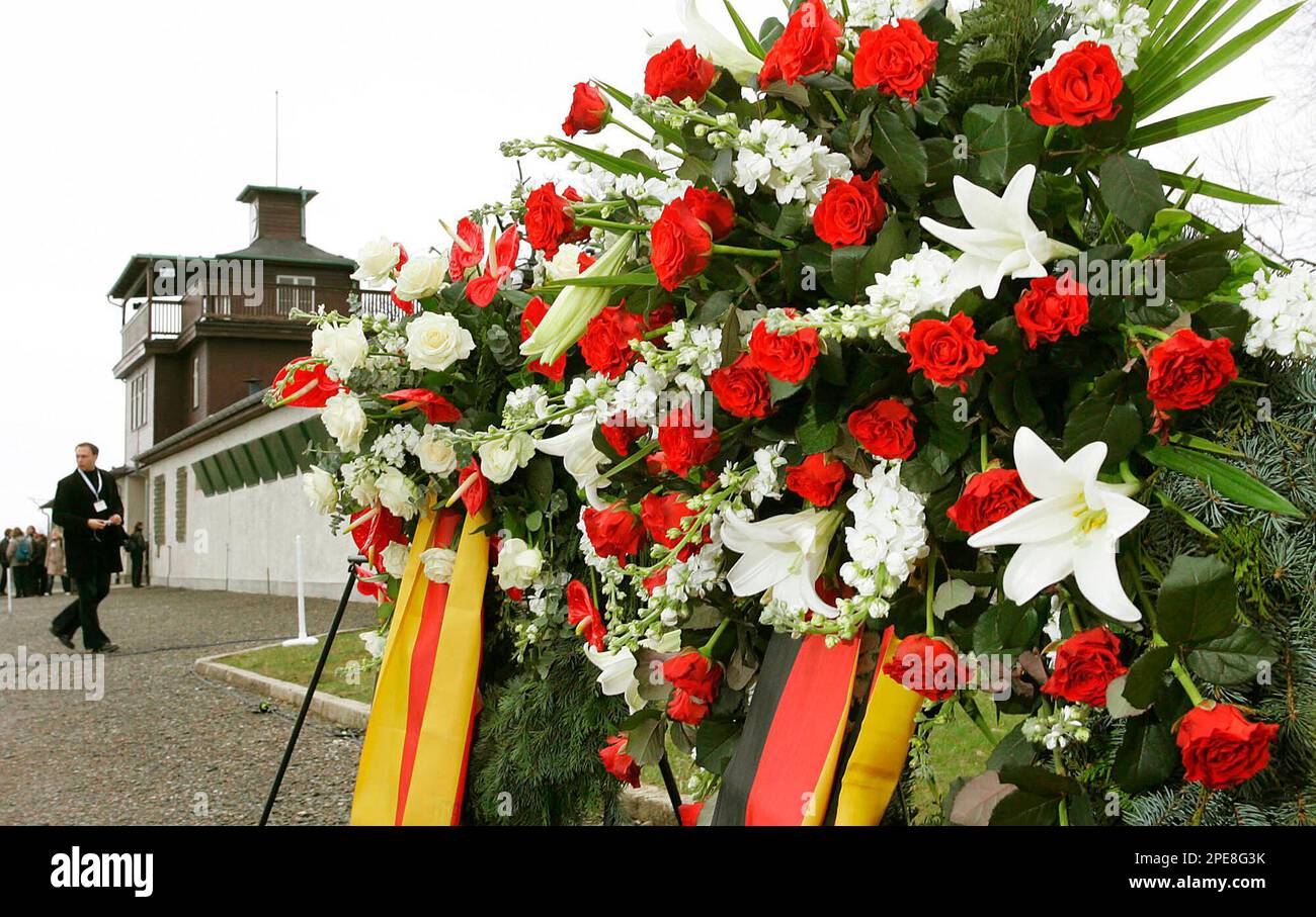 Wreaths, with ribbons attached in the colours of the German flag, stand ...