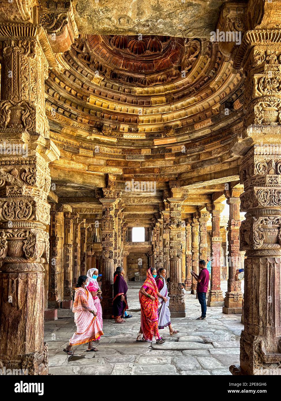 Local tourists walking amongst the Intricately carved stone cloister ...