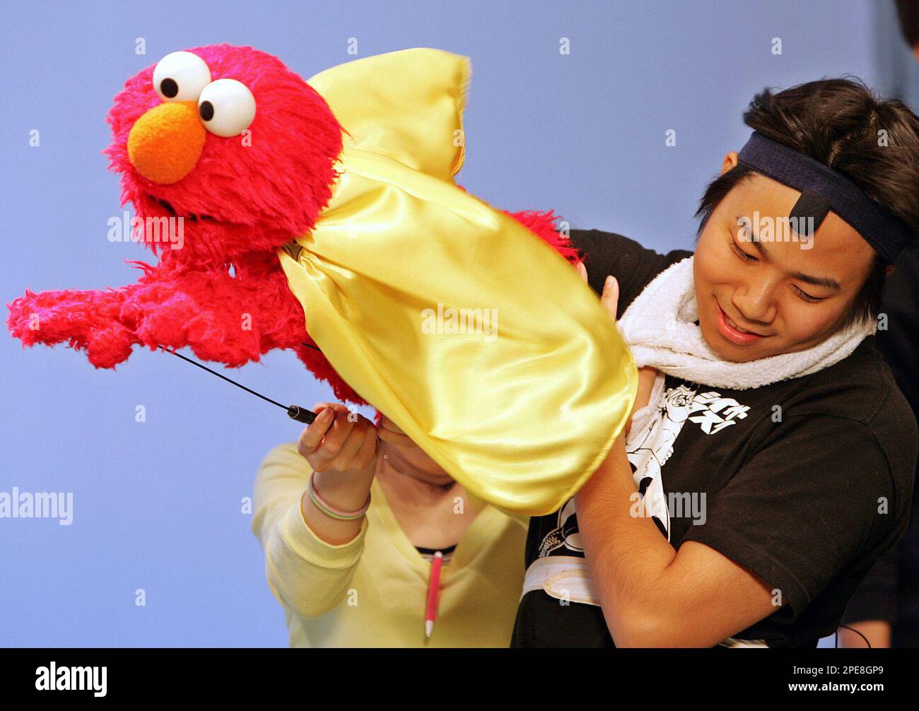 Kenta Matsumoto, a Muppet operator, handles Elmo, a popular Sesame ...