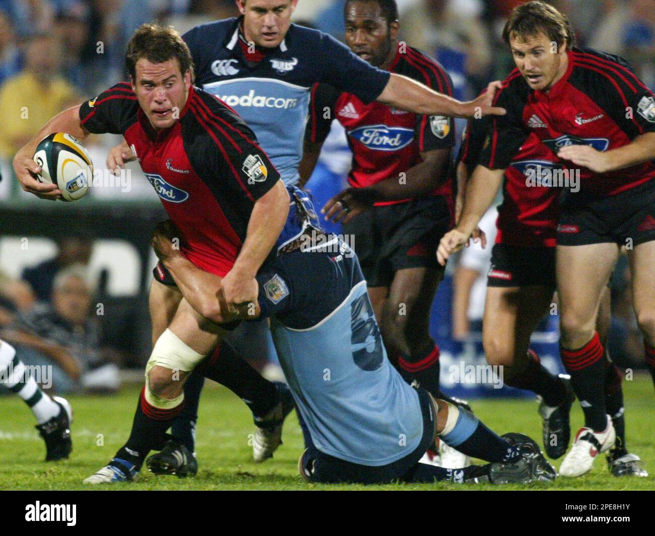 South African Bulls Victor Matfield, second from left, tackles ...