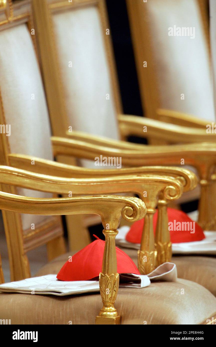 Cardinal skullcaps are placed on empty chairs during a Mass celebrated ...