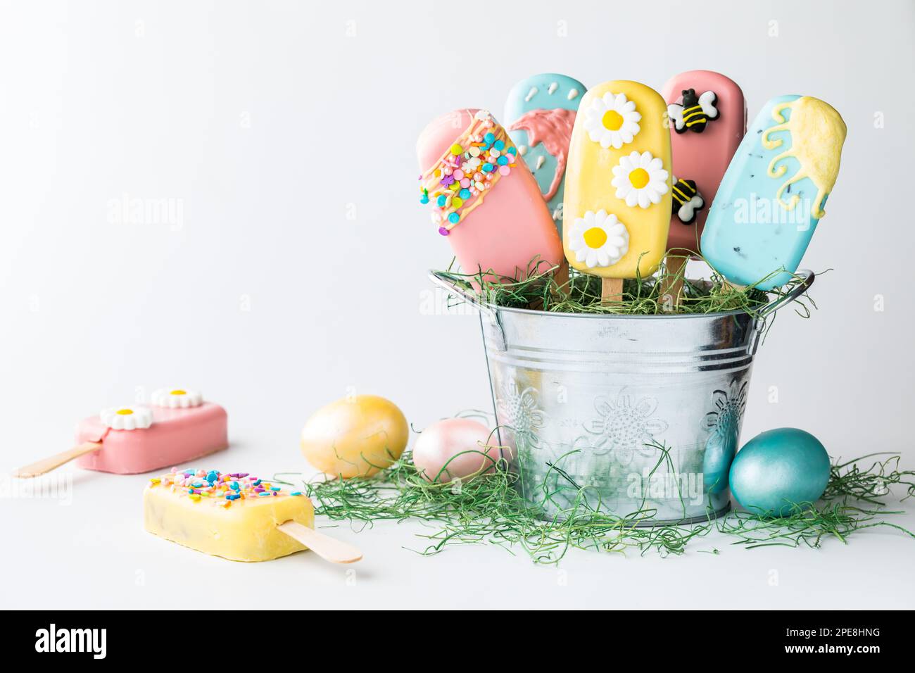 Easter themed cakesicles in a tin pail against a light background Stock ...