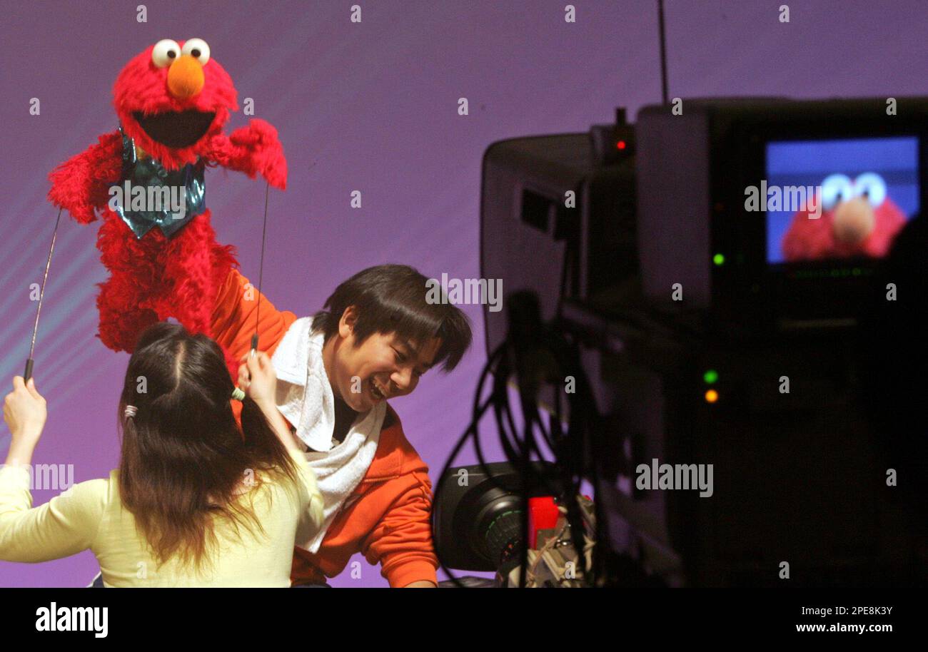 Kenta Matsumoto, a Muppet operator, handles Elmo, a popular Sesame ...