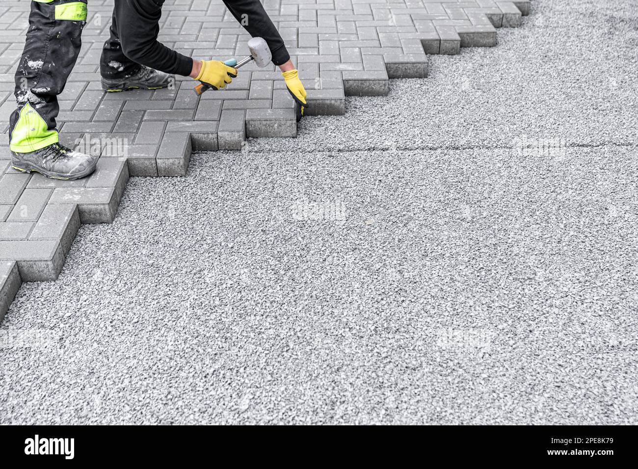 rubber hammer for adjusting the lock paving on the sidewalk Stock Photo ...