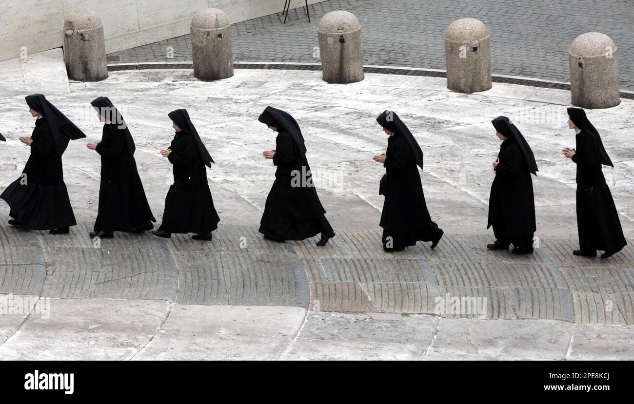 Nuns walk in line in St. Peter's Square at the Vatican, Friday April 8 ...