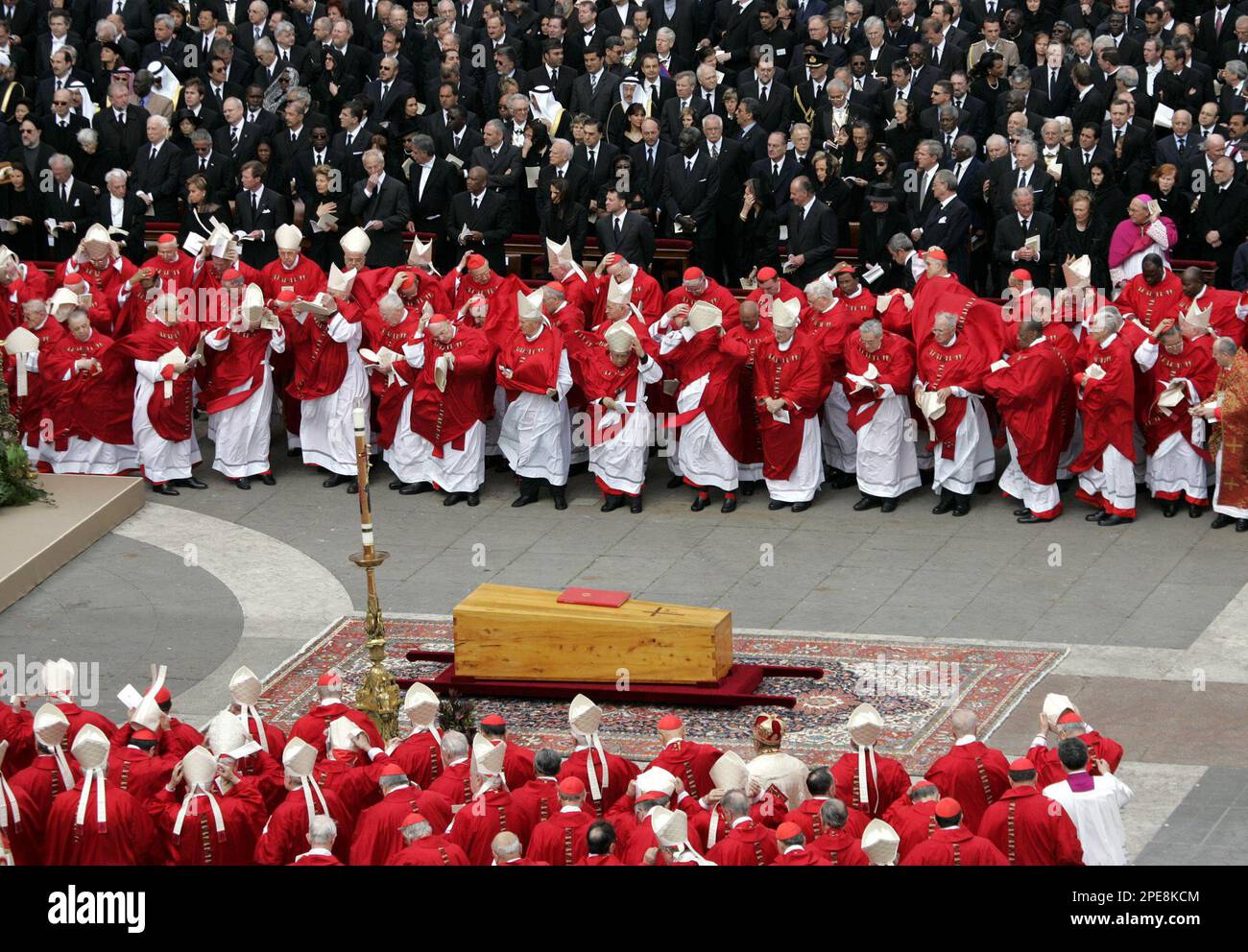 Cardinal hold on to their mitres as wind blows in St. Peter's Square at ...