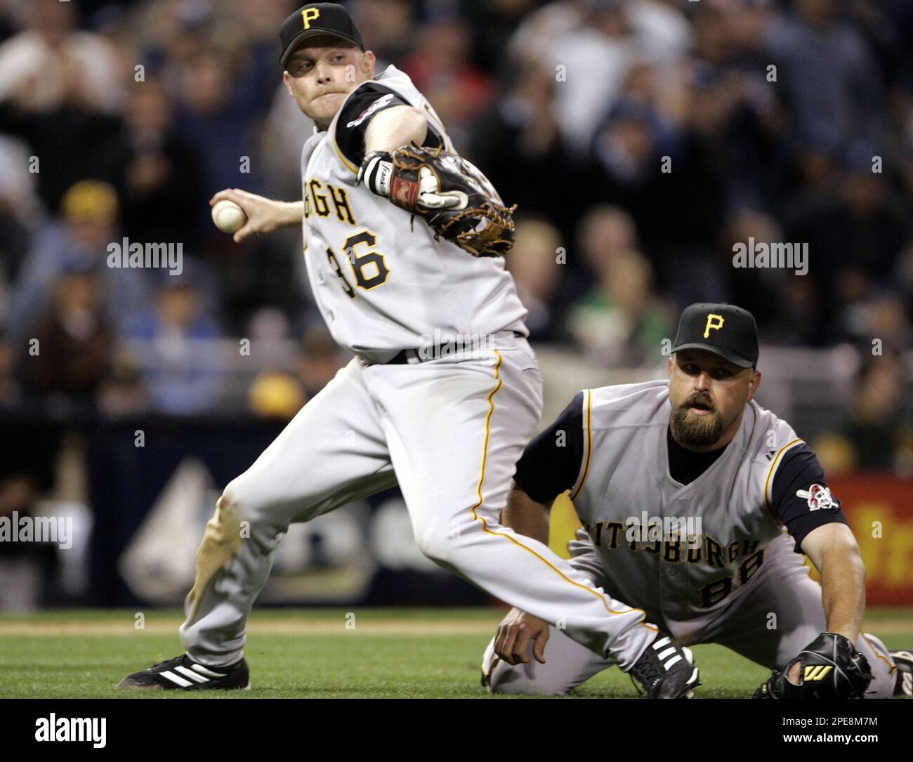 Pittsburgh Pirates first baseman Craig Wilson throws to first to nip ...