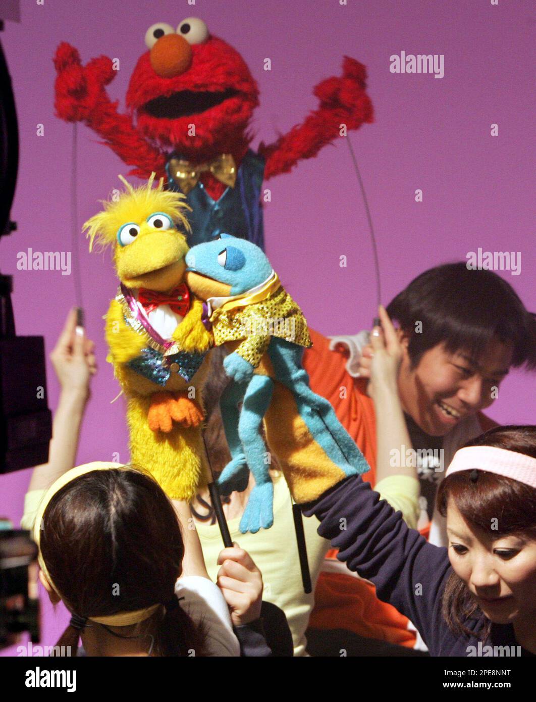 Muppet operators, handles Elmo, a popular Sesame Street character, and ...