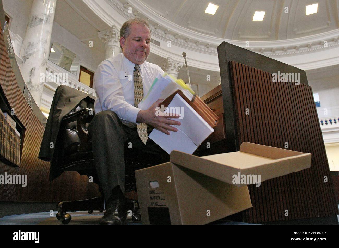 Rep.William Sali, R-Kuna, packs a cardboard box with papers from his ...